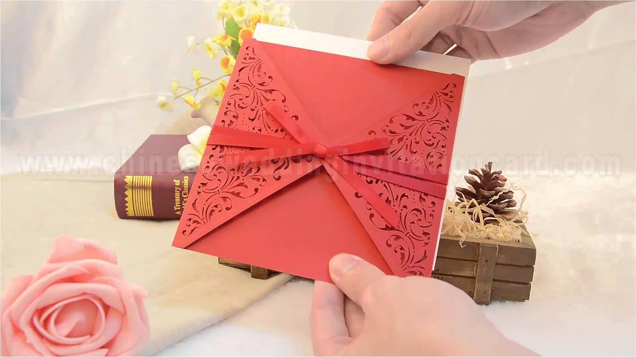 pierced traditional chinese style wedding invitation card tied by red ribbon