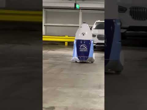 Safety Patrol Robot Patrolling The Parking Garage At The Houston Airport. Parking Lot Robot Cameras