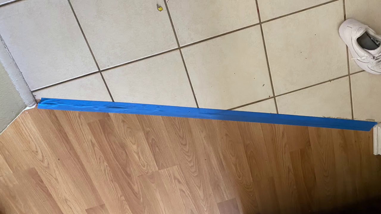 Installing a transition strip from tile to laminate flooring