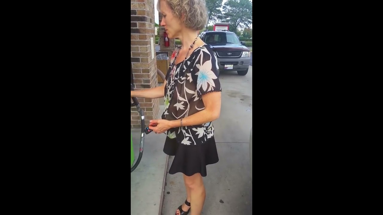 Pumping gas in high heels and sheer blouse braless