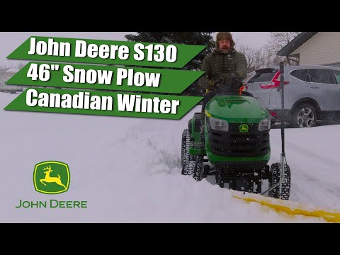 John Deere S130 Tractor with Snow Plow Pushing Snow