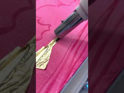 Artist uses a vacuum to clean up the excess gold leaf!
