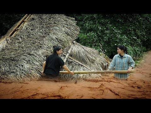 Ly Tieu Isa helps Ly Tieu Nu clean up her house that was washed away after the storm.
