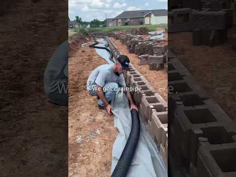 The wall is going up! #landscaping #retainingwall #lawncare #construction