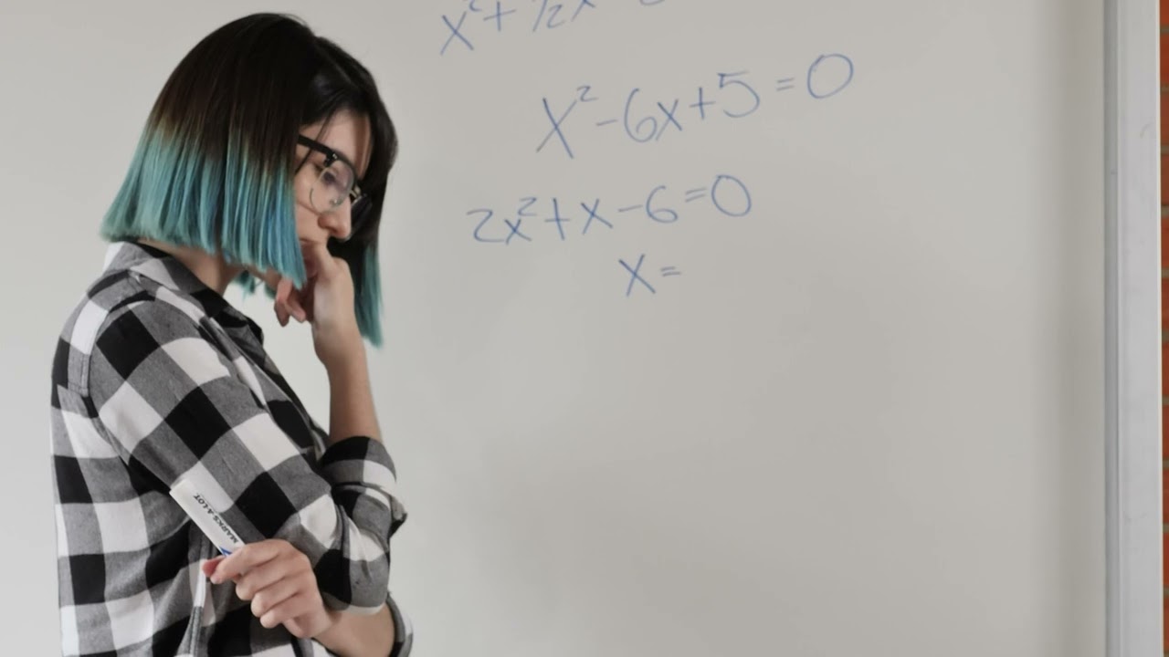 Student girl trying to solve equations on the whiteboard | Free Stock Footage - No Copyright