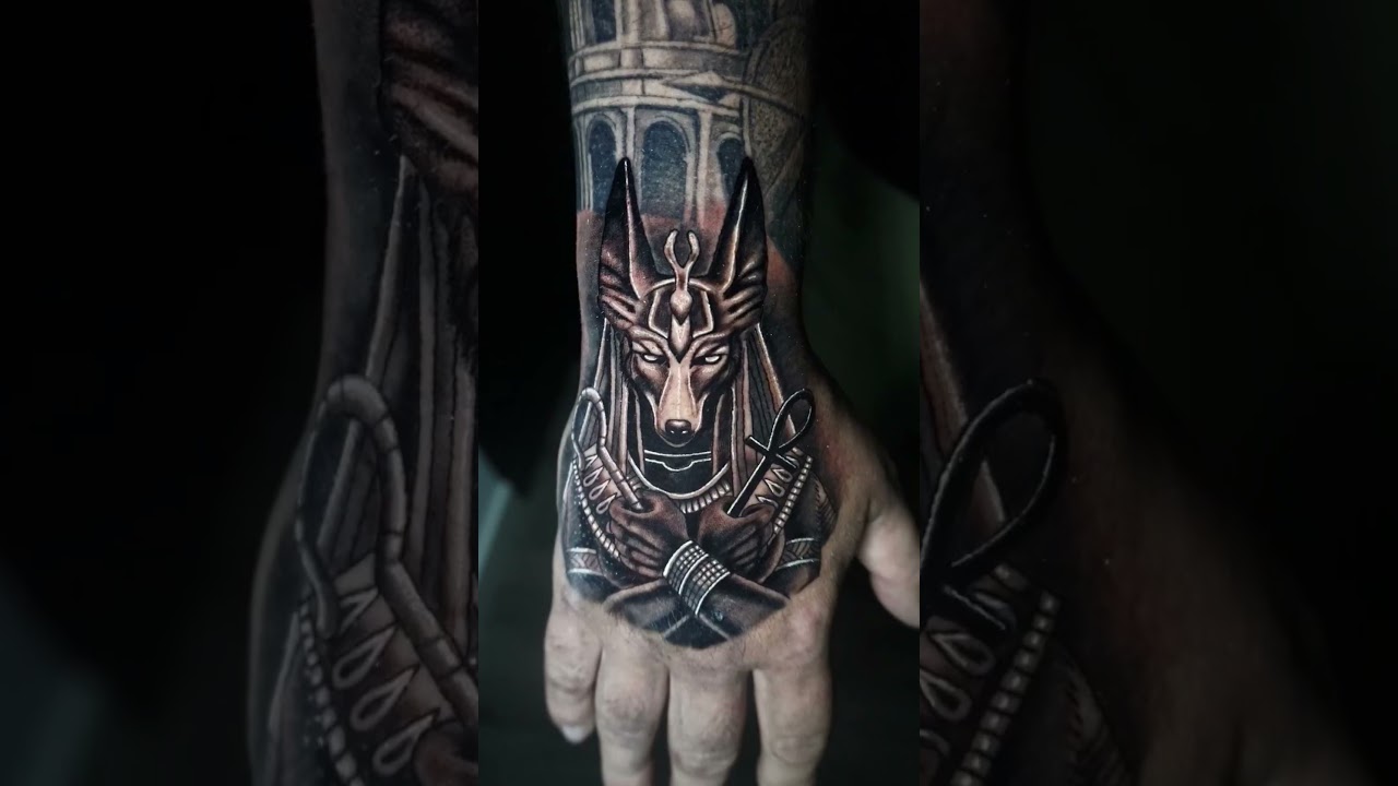 Anubis Hand Tattoo – Black & Grey Realism