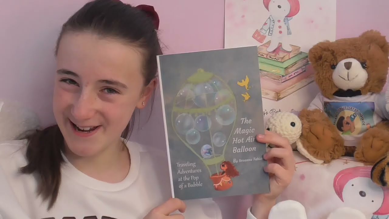 Ruby reads 'The Magic Hot Air Balloon. Traveling Adventures at the Pop of a Bubble.' By B. Fabian.