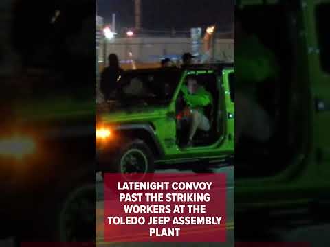 Convoy of supporters drive past striking workers at Toledo Jeep plant