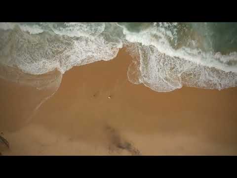 aerial view waves break on white sand beach sea w 2024 10 17 16 30 13 utc
