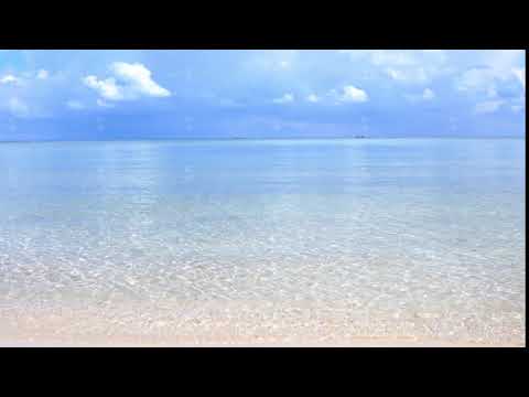 Panoramic landscape of amazing tropical beach. Ocean waves and cloudy sky background. White sand and