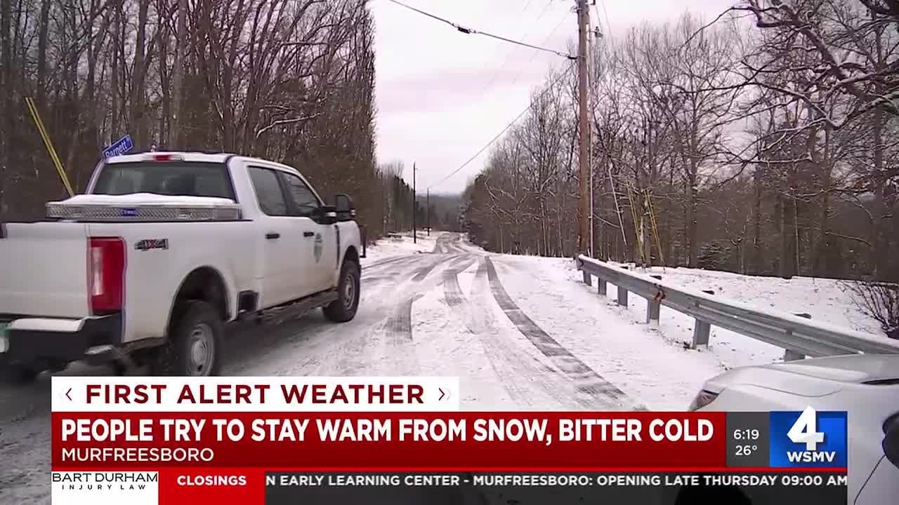 People try to stay warm from snow, bitter cold