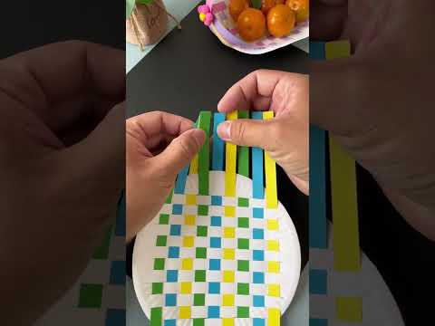 Use disposable plates and colored paper strips to decorate a beautiful fruit basket. Try it now.