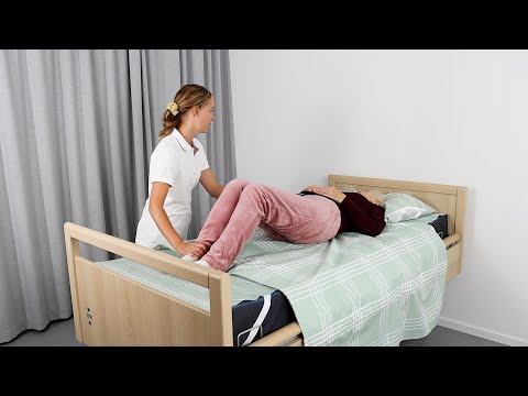 Immedia SatinSheet – One carer supporting a user to move higher up in bed independently