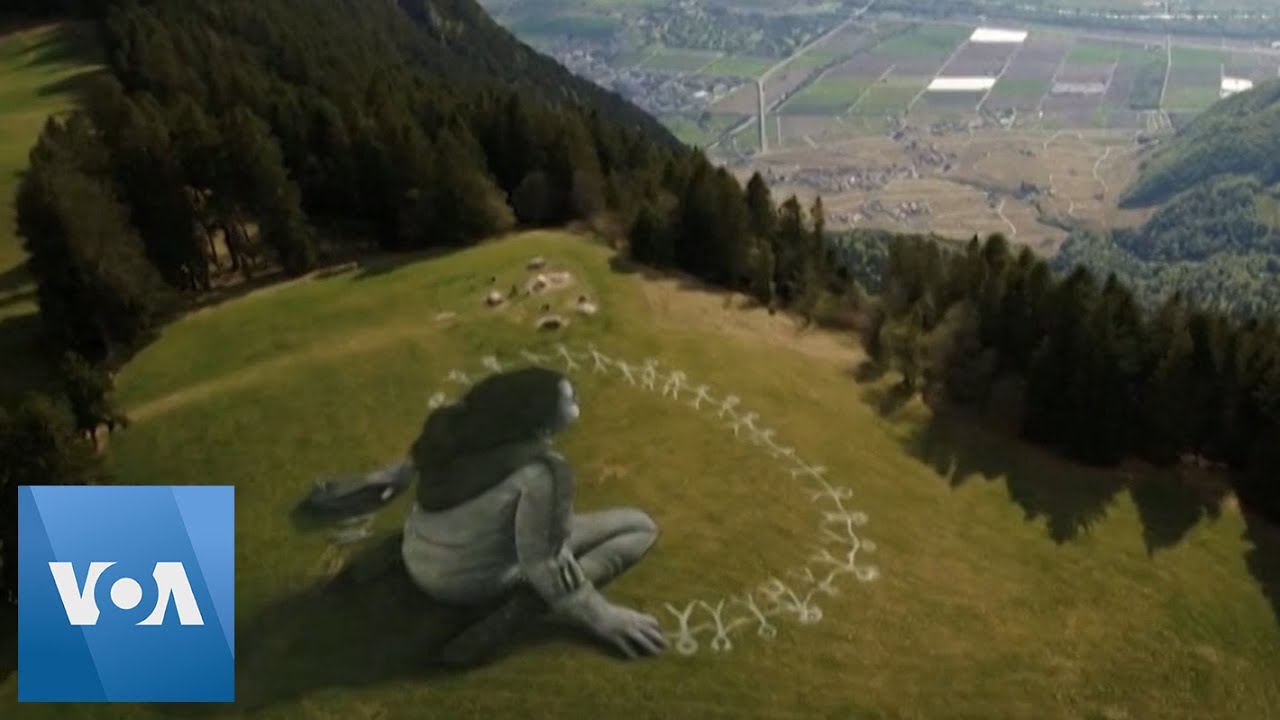 Land Artist Unveils Giant Coronavirus-Themed Piece in Swiss Alps