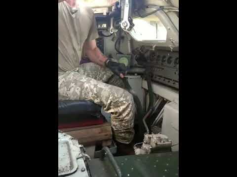 Soldier driving military tank