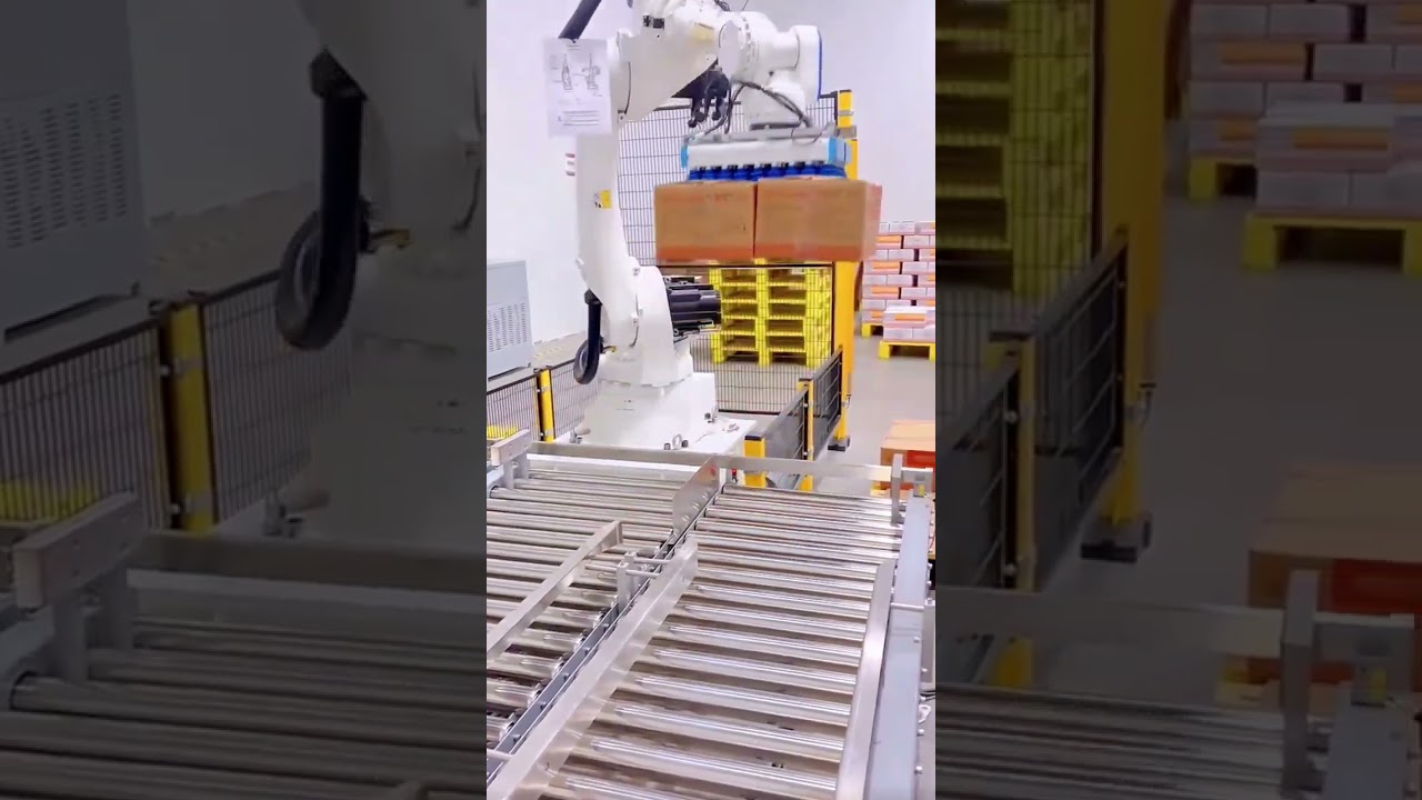 Robotic arm stacking cardboard boxes on conveyor
