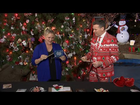 Jude and Kim open up memory ornaments for the Jingle Tree