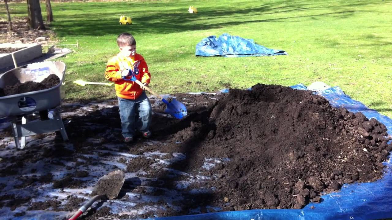 Shoveling Compost into Our Wheelbarrow - Filling Our New Garden Boxes
