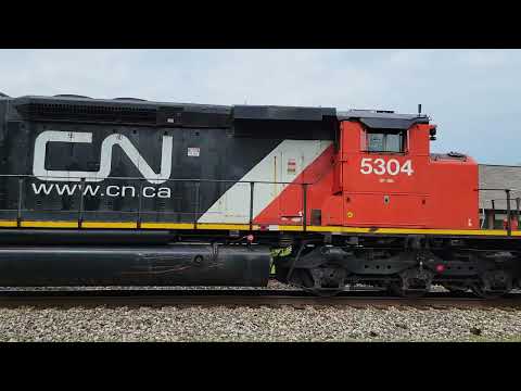 CN 5444, 5304 curve a Westbound local freight train with gondolas, hoppers through Vicksburg, MI