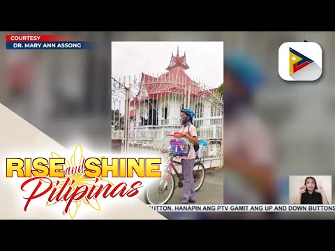 Larawan ng guro na nakabisikleta habang may dalang learning modules, wagi sa isang photo contest