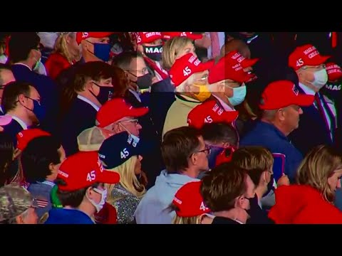 Gov. Kim Reynolds without a mask for a short time during Trump rally