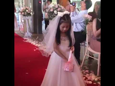 Zoey walking down the aisle as flower girl at Ken and Sarah’s wedding