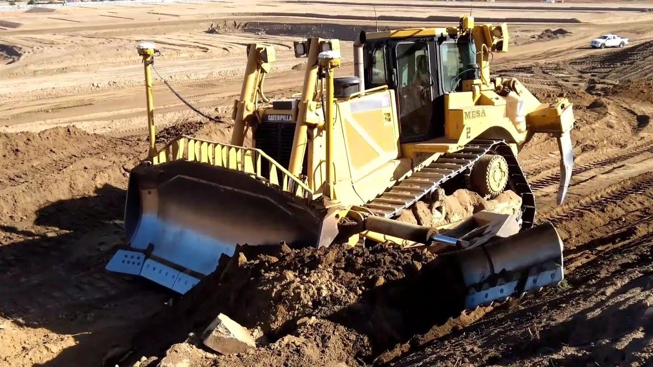 CAT D8T Dozer cutting slope with slope board- full pass