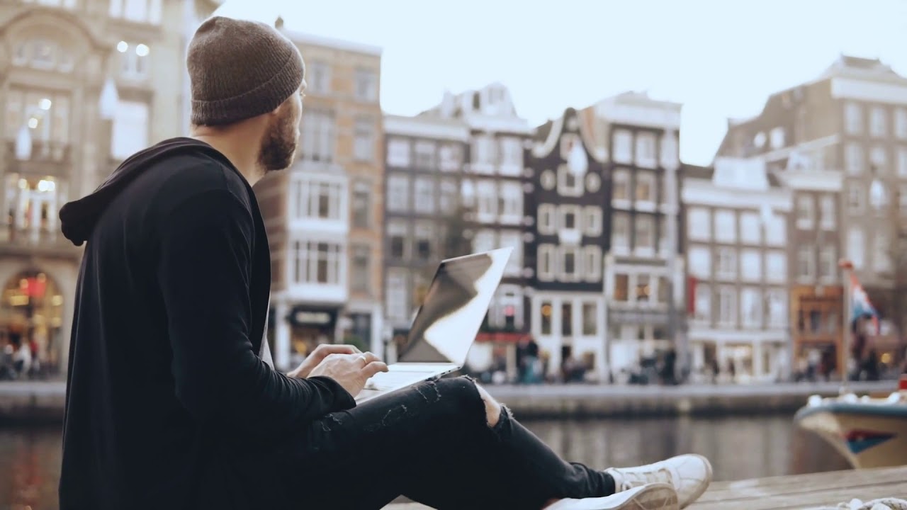 videoblocks 4k young caucasian man works with laptop outside creative worker looking for inspiration