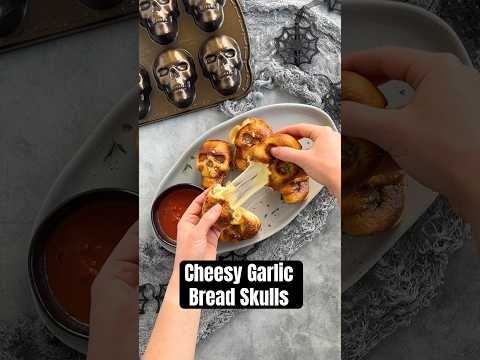 Cheesy Garlic Bread Skulls for Halloween made in Haunted Skull Cakelet Pan! Recipe on our website!