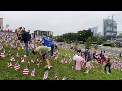 Volunteers and service members plant 12,000 American flags to honor fallen Virginians at the