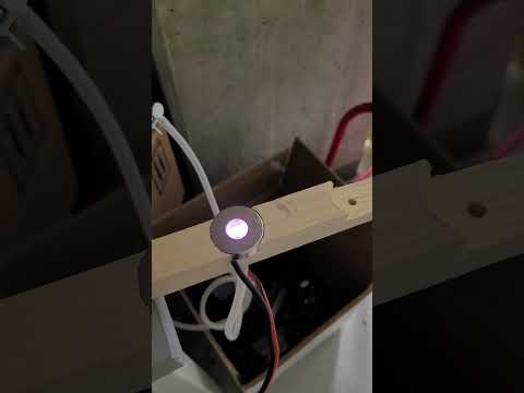 Oil burner ignition coil arc in magnetic field, with strong airflow through arc