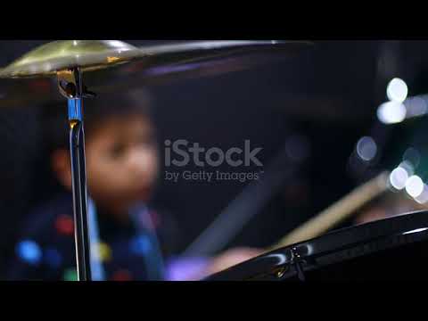 Blurry kid learning and play drum set in music room. The concept of musical instrument. 4K