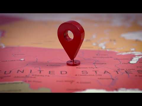Slow rotating shot of 3d printed location GPS icon on the map of United States of America USA