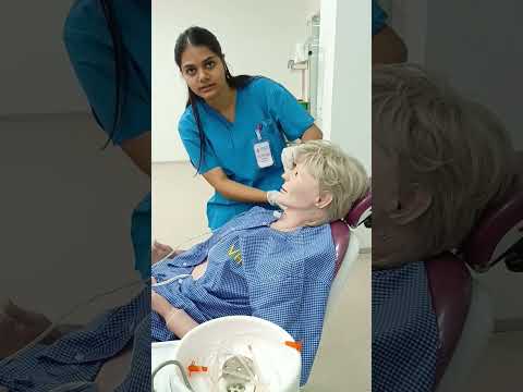 Taking the measurements for the insertion of Ryles Tube to feed patient.