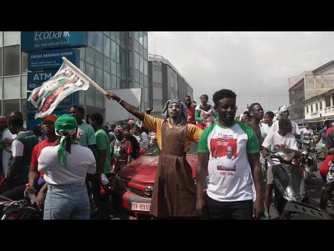 Supporters of Ghana's opposition party celebrate in the streets of Accra after ruling party concedes