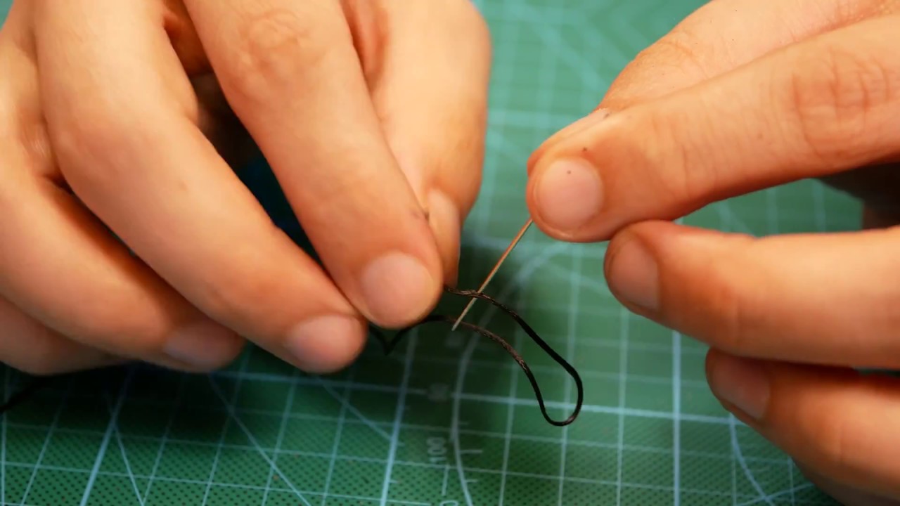 Thread a needle for sewing leather