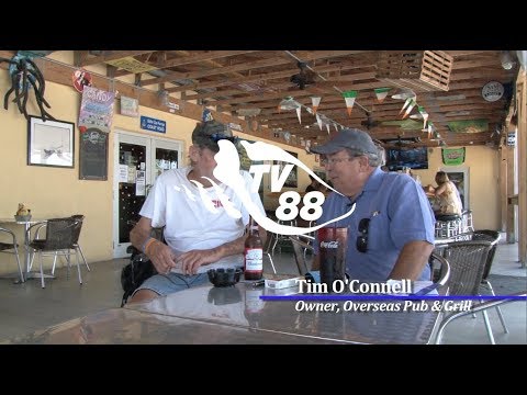 Overseas Pub & Grill owner, Tim O'Connell chats with a longtime customer- Marathon, Florida Keys