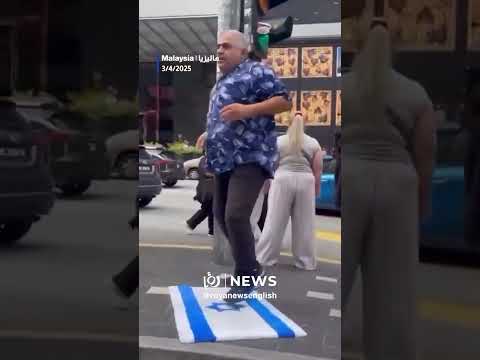 People in Kuala Lumpur turn 'Israeli' flag into a mat