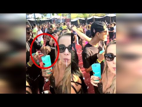 Guy caught on camera spiking girl's drink at festival