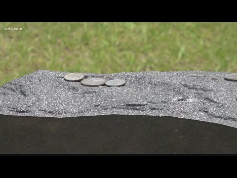 Coins on military headstones and what it means