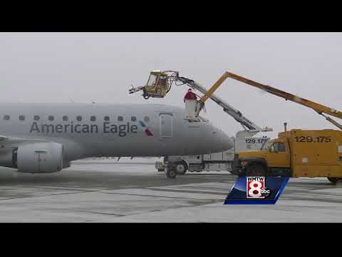 Crews work to de-ice planes at Portland Jetport