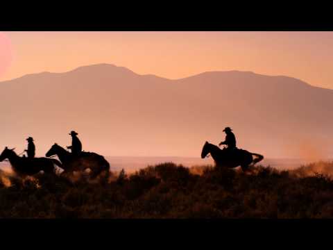 Slow Motion Silhouette Shot Of Cowboys Galloping Horses In 4K & Ultra HD Stock Footage