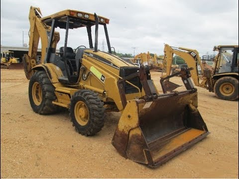 Cat 416C Backhoe Moving Brush