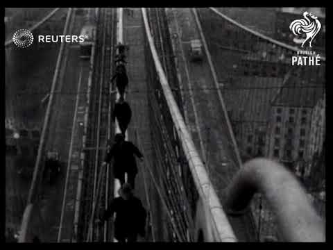 Workers inspect Brooklyn Bridge for damage (1923)