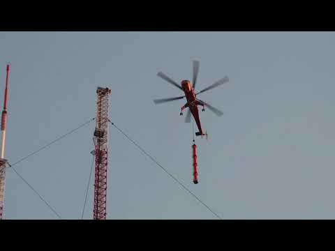 Sikorsky helicoptor lowers top of TV tower in Shoreview, MN
