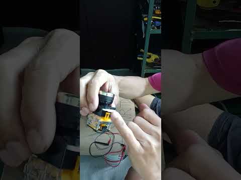 910. PUSH BUTTON SWITCH Device/shown how to press the LOCK to disengage the Button
