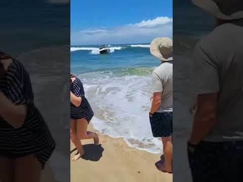 Boat rides the surf onto the beach
