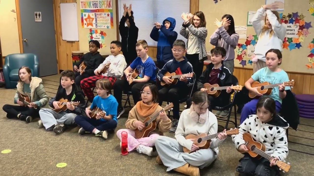 McKenny 5th graders play school song on ukuleles.