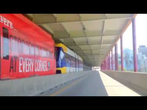 Crossing Washington Avenue Bridge Minneapolis along side METRO Green Line