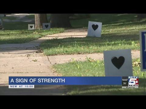 Local teens selling signs with black hearts on them share unspoken meaning